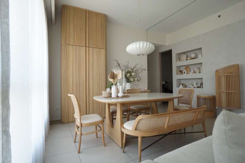 A modern quartz or marble dining table with a sleek, rounded ...